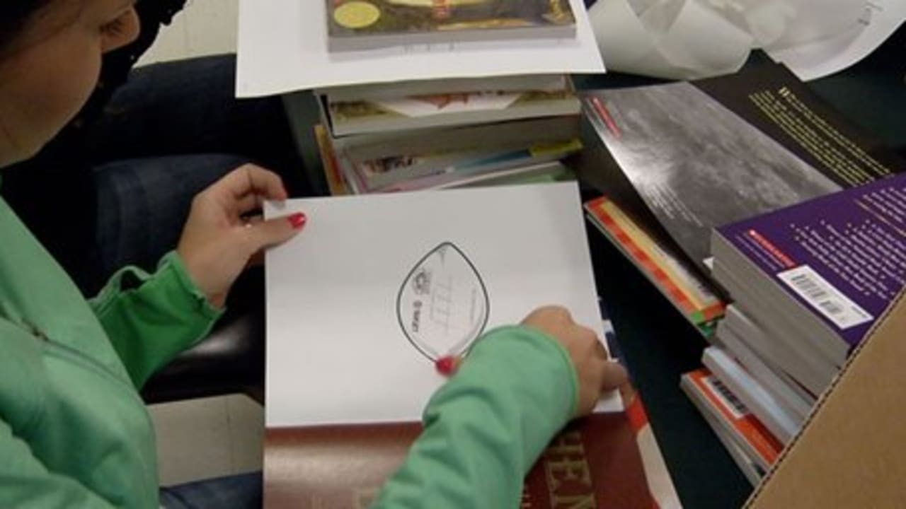 EYP Places Name Stickers In Books