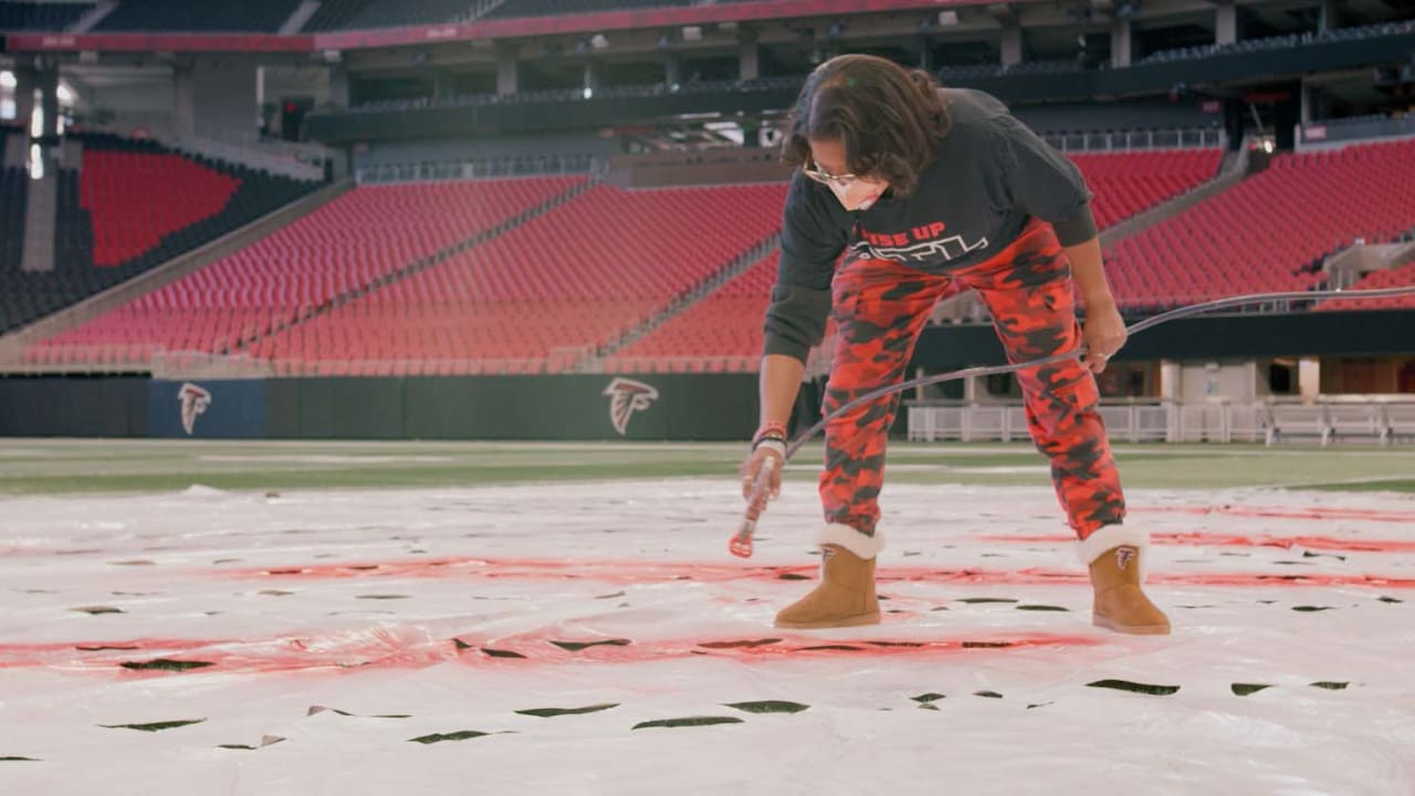 Season ticket members help paint field for gameday