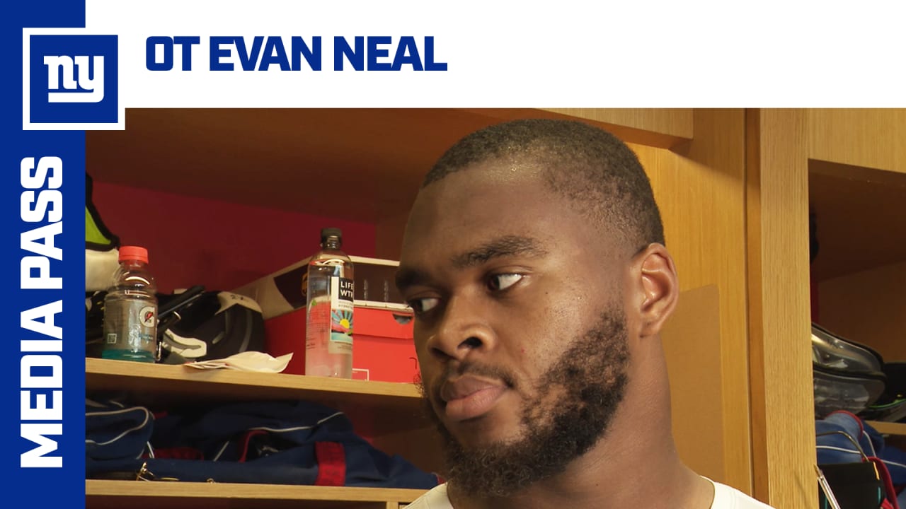 Evan Neal speaks with the media following Thursday's practice