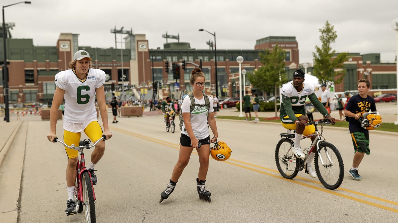 Packers ride kids' bikes to practice
