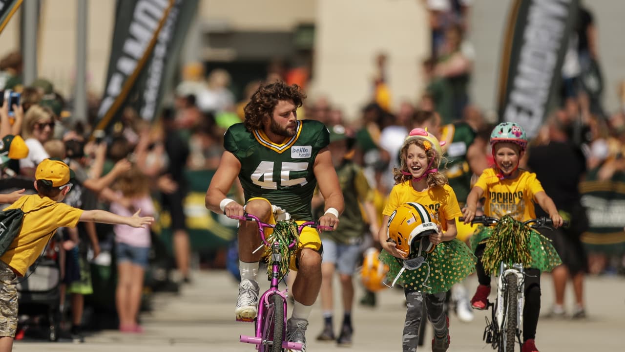 Packers ride kid's bikes to Ray Nitschke Field