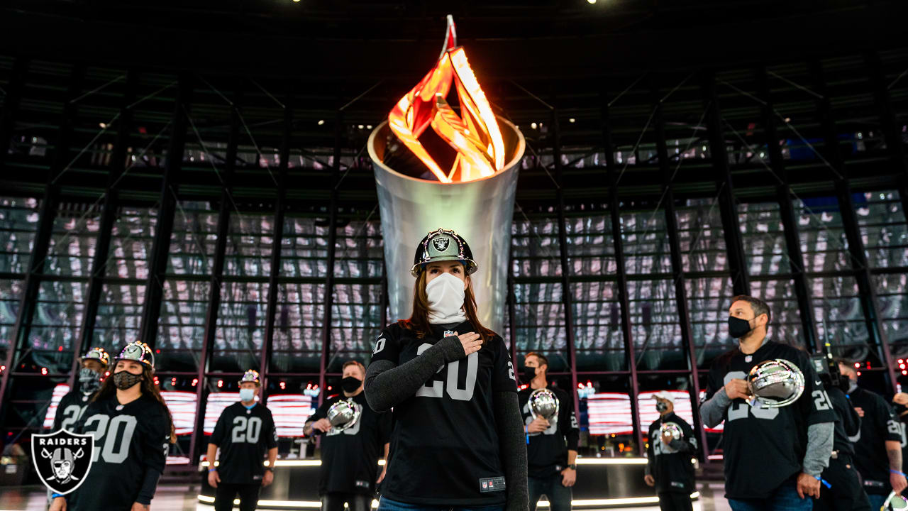 Allegiant Stadium construction workers light Al Davis Memorial Torch