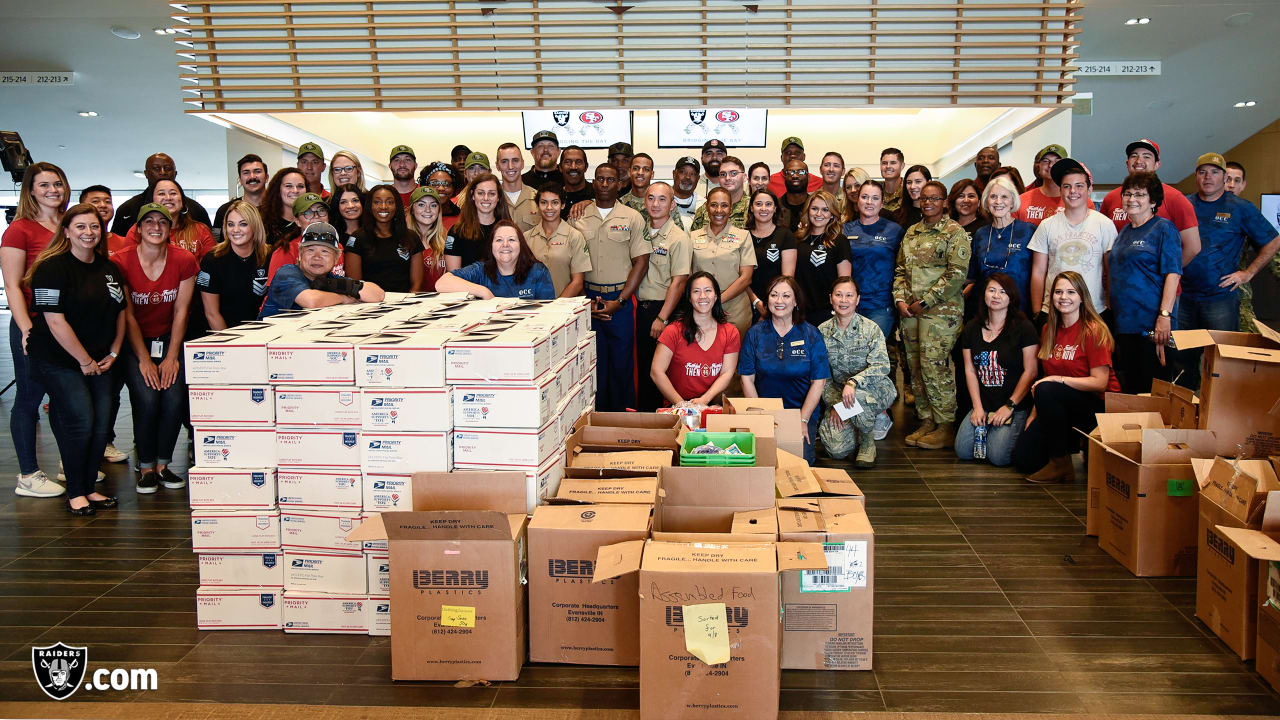 Raiders and 49ers Alumni package kits for troops overseas