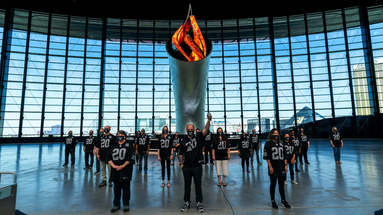 Frontline medical workers light Al Davis Memorial Torch