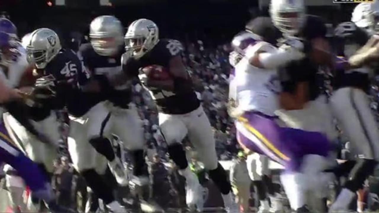 Raiders Latavius Murray drags defenders for a gain of 14 yards