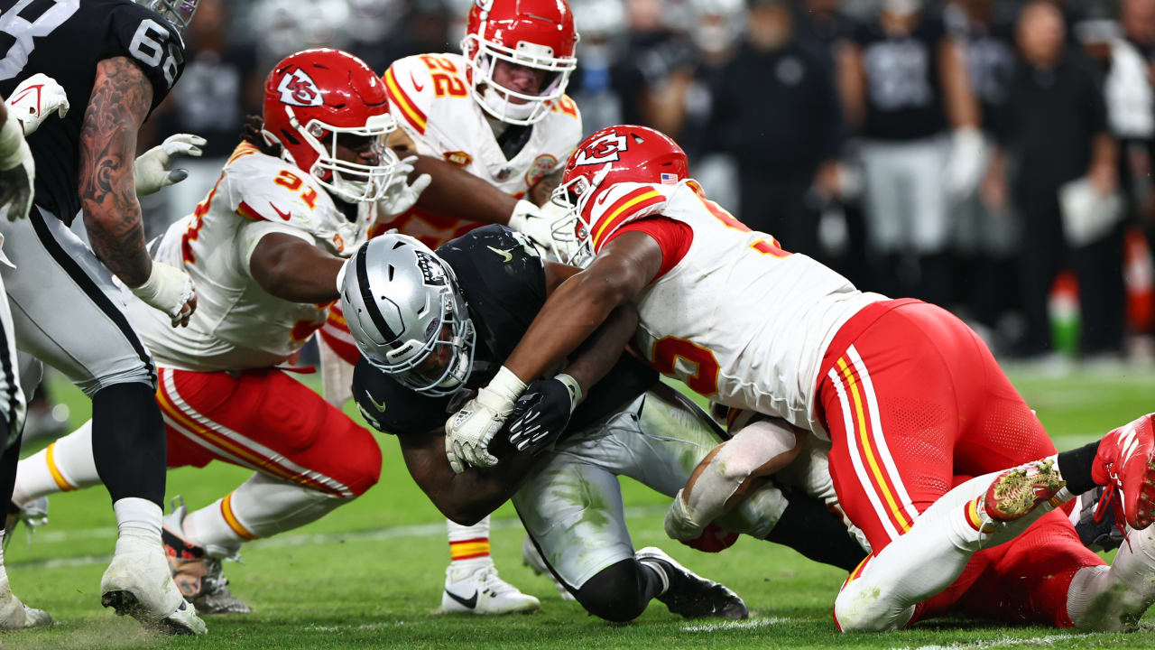 Kansas City Chiefs defensive lineman Chris Jones leads a swarm of ...